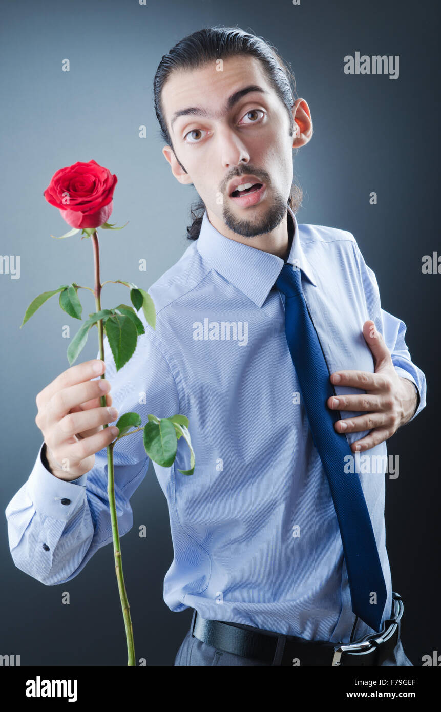 Young man with red rose Stock Photo - Alamy