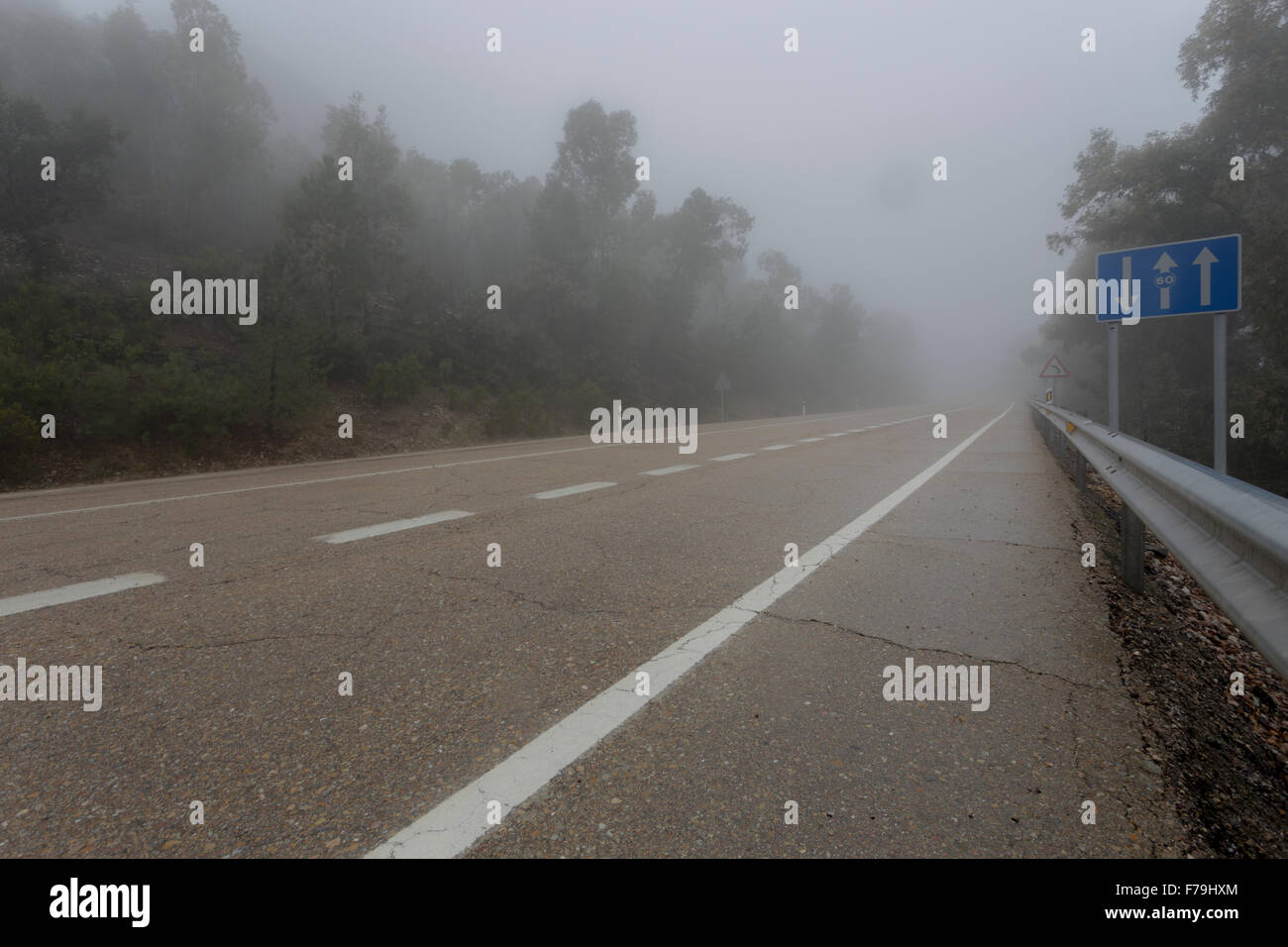 lonely country road without cars and foggy Stock Photo - Alamy