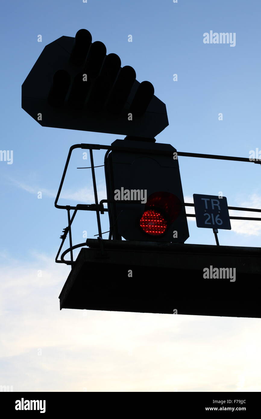 Looking up at the almost black signal head showing a red aspect and ...