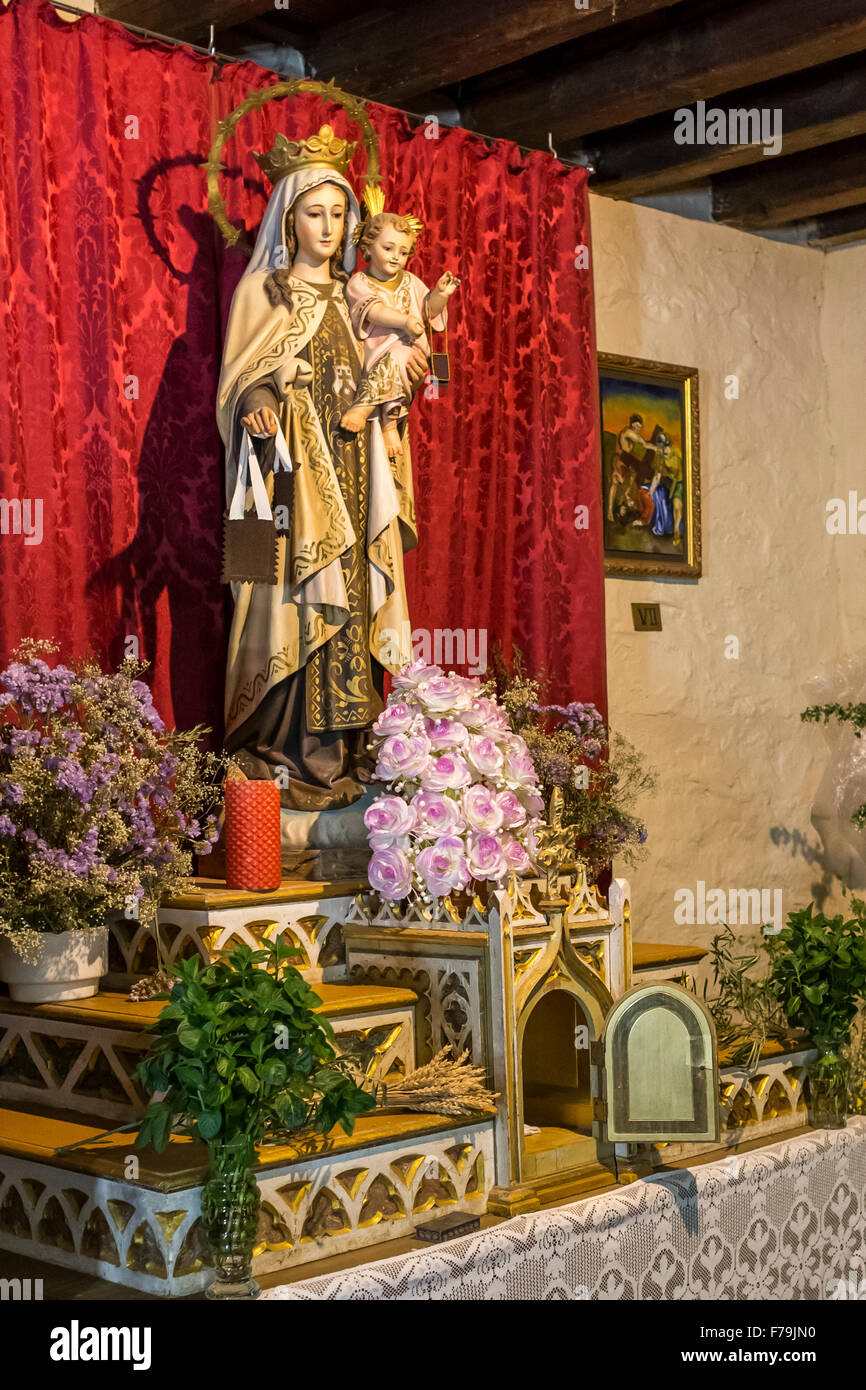 Jesus figure inside a church at night Stock Photo - Alamy