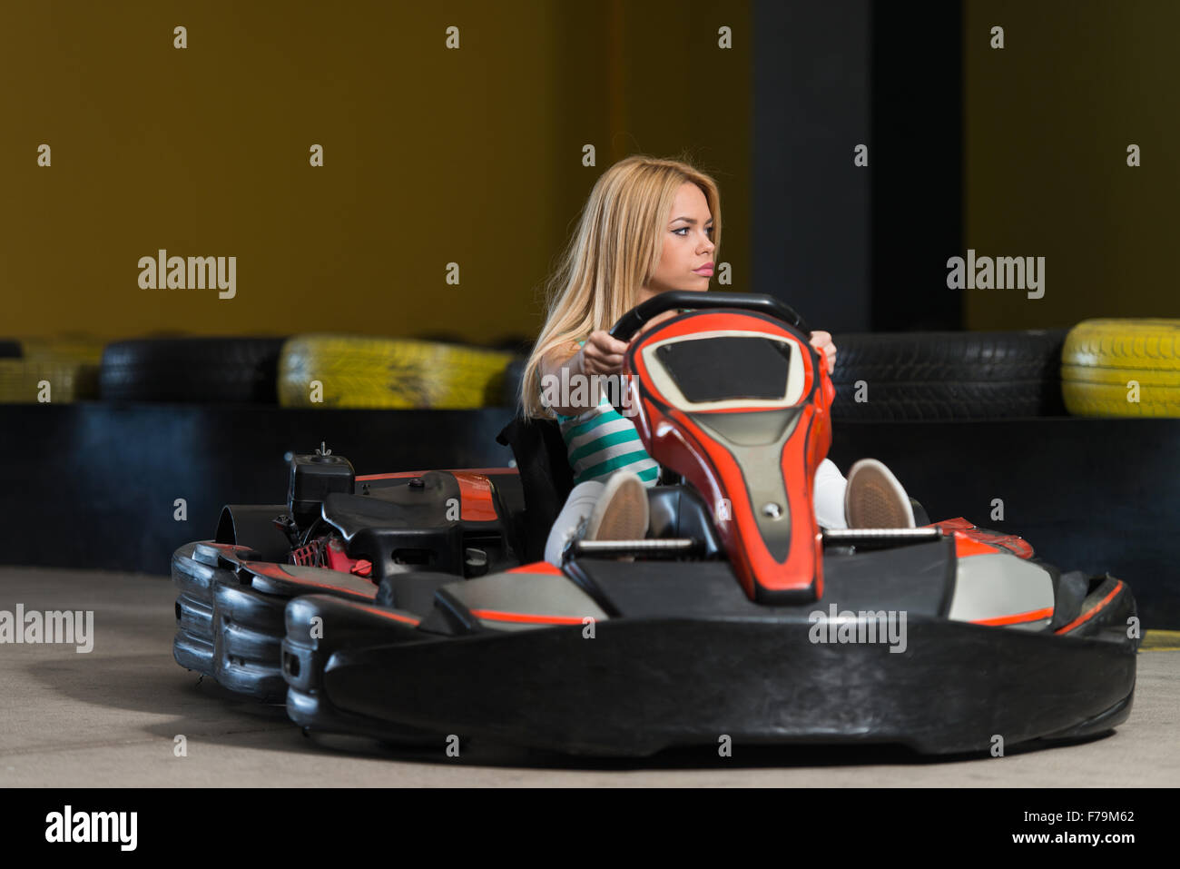 Young Woman Is Driving Go-Kart Car With Speed In A Playground Racing ...