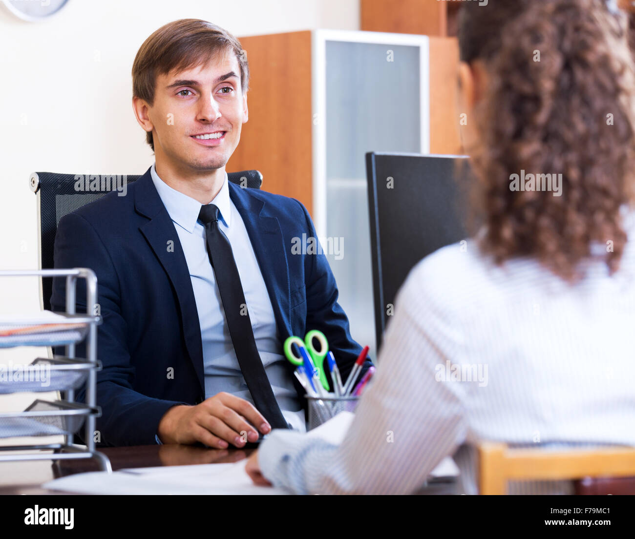 Young male happy hr manager inreviewing competitor for avalible vacancy ...