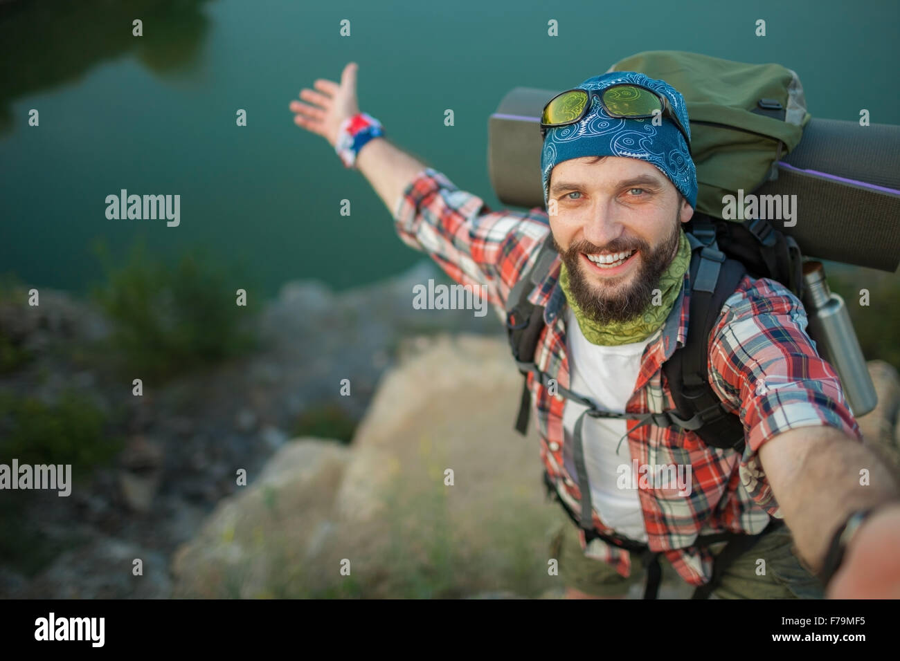 fully equipped tourist smiling on the background of lake Stock Photo ...