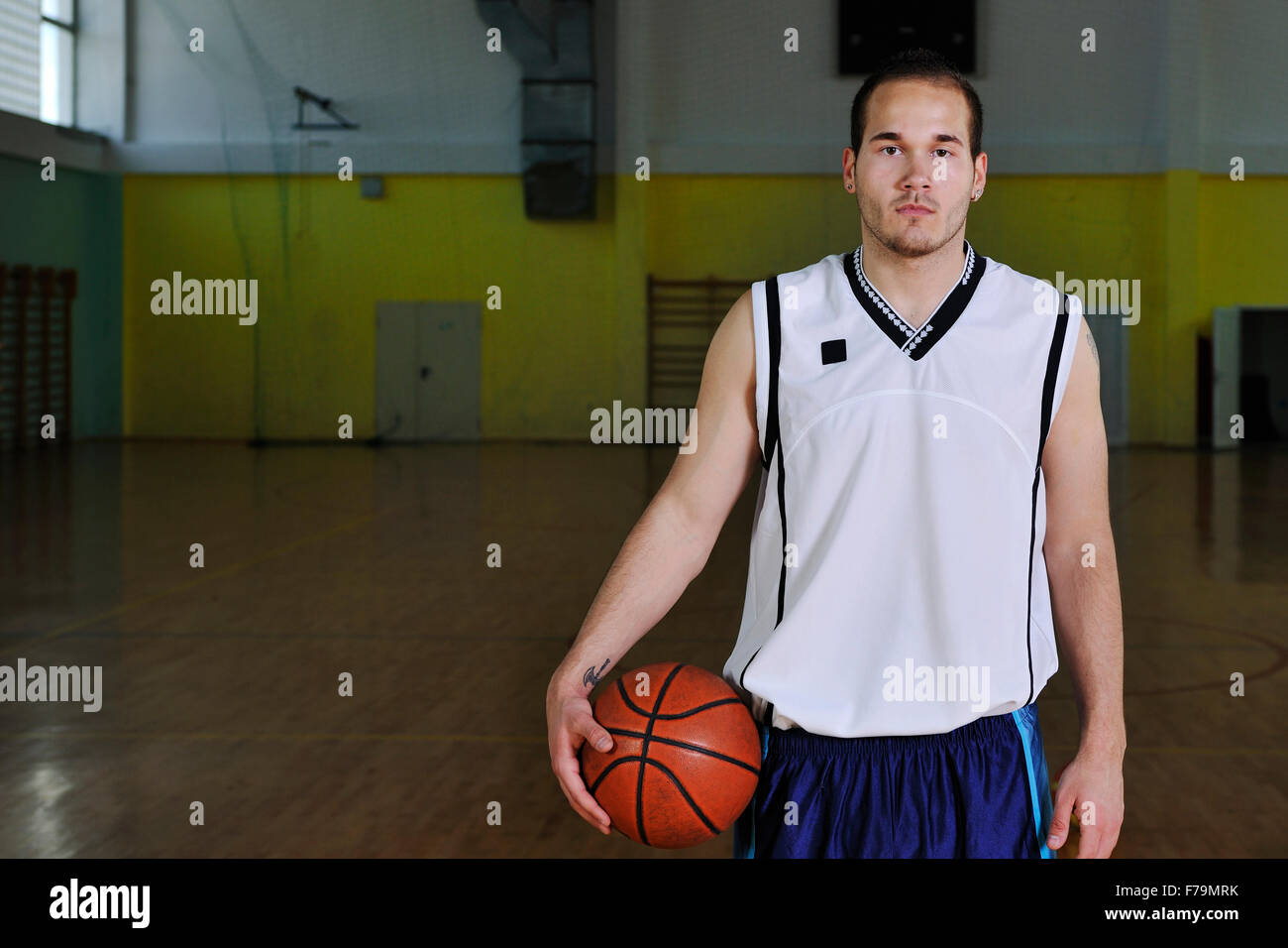 one healthy young man play basketball game in school gym indoor relax ...