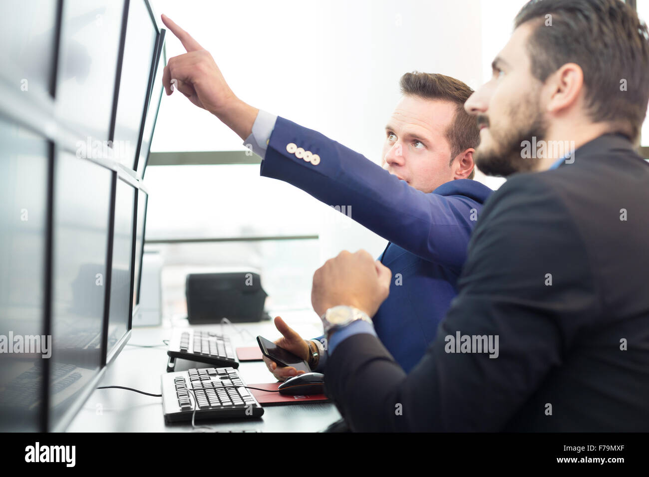 Stock traders looking at computer screens Stock Photo - Alamy
