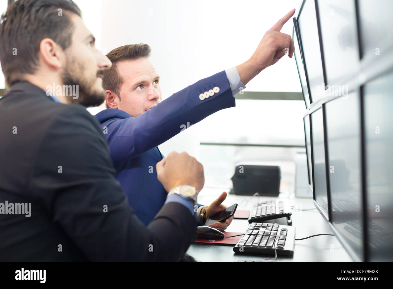 Stock traders looking at computer screens Stock Photo - Alamy