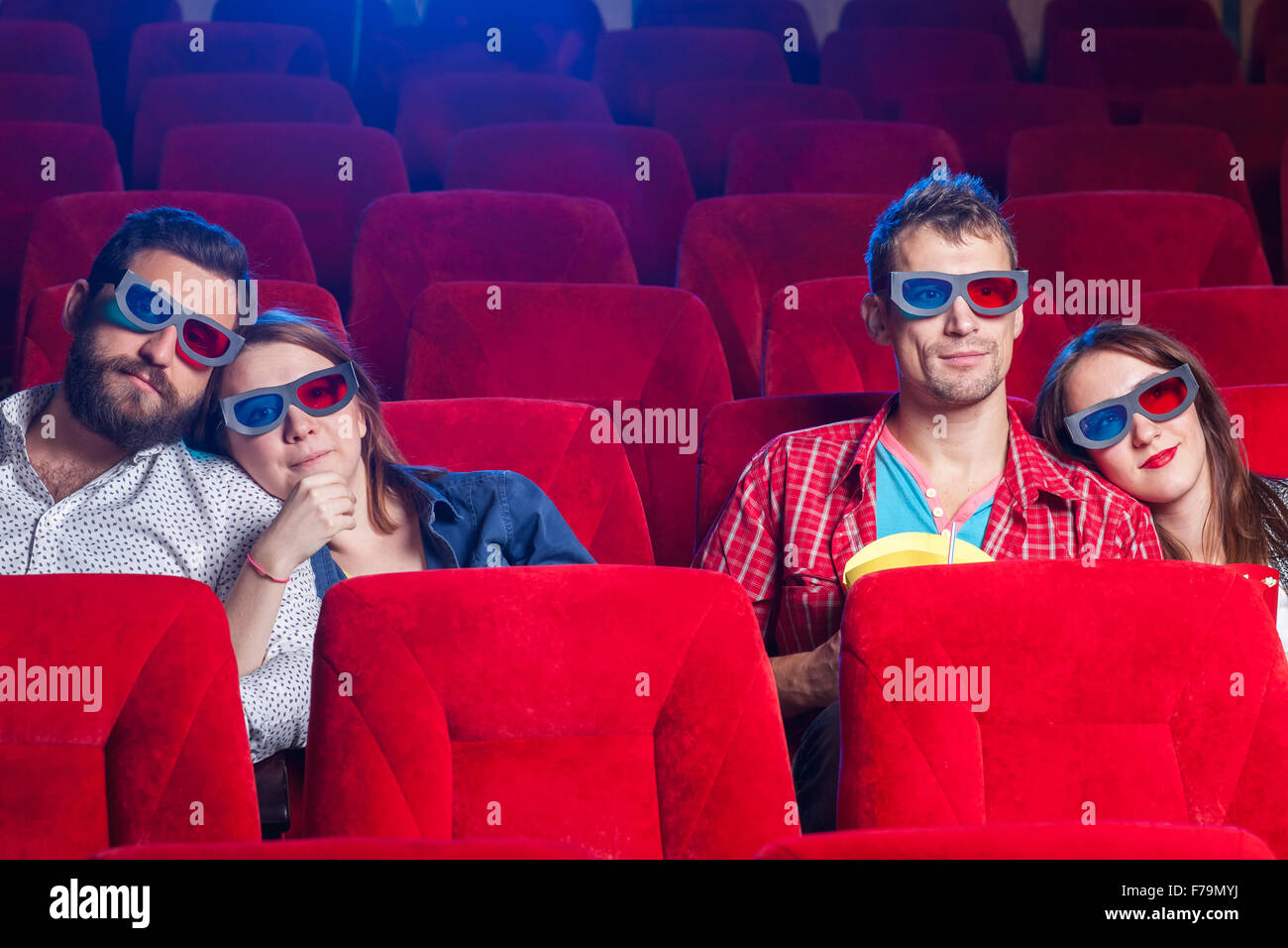 A variety of human emotions of friends holding a cola and popcorn in ...