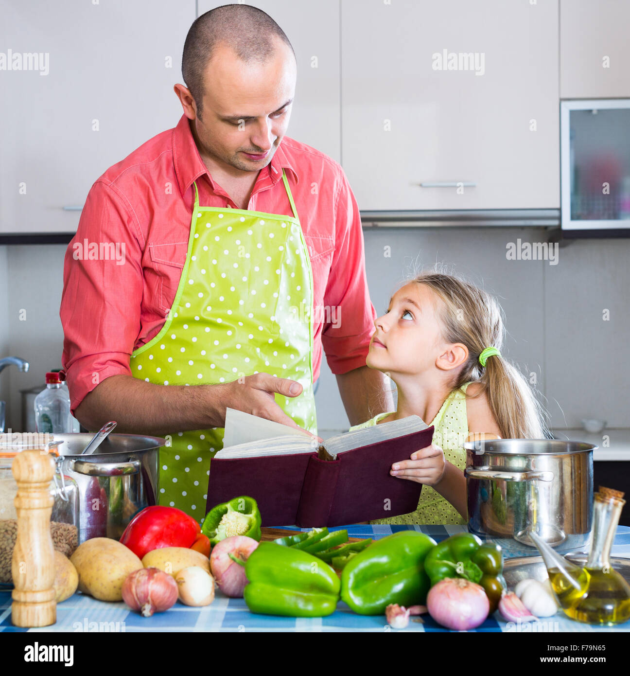 Little girl helping father to prepare dinner Stock Photo - Alamy