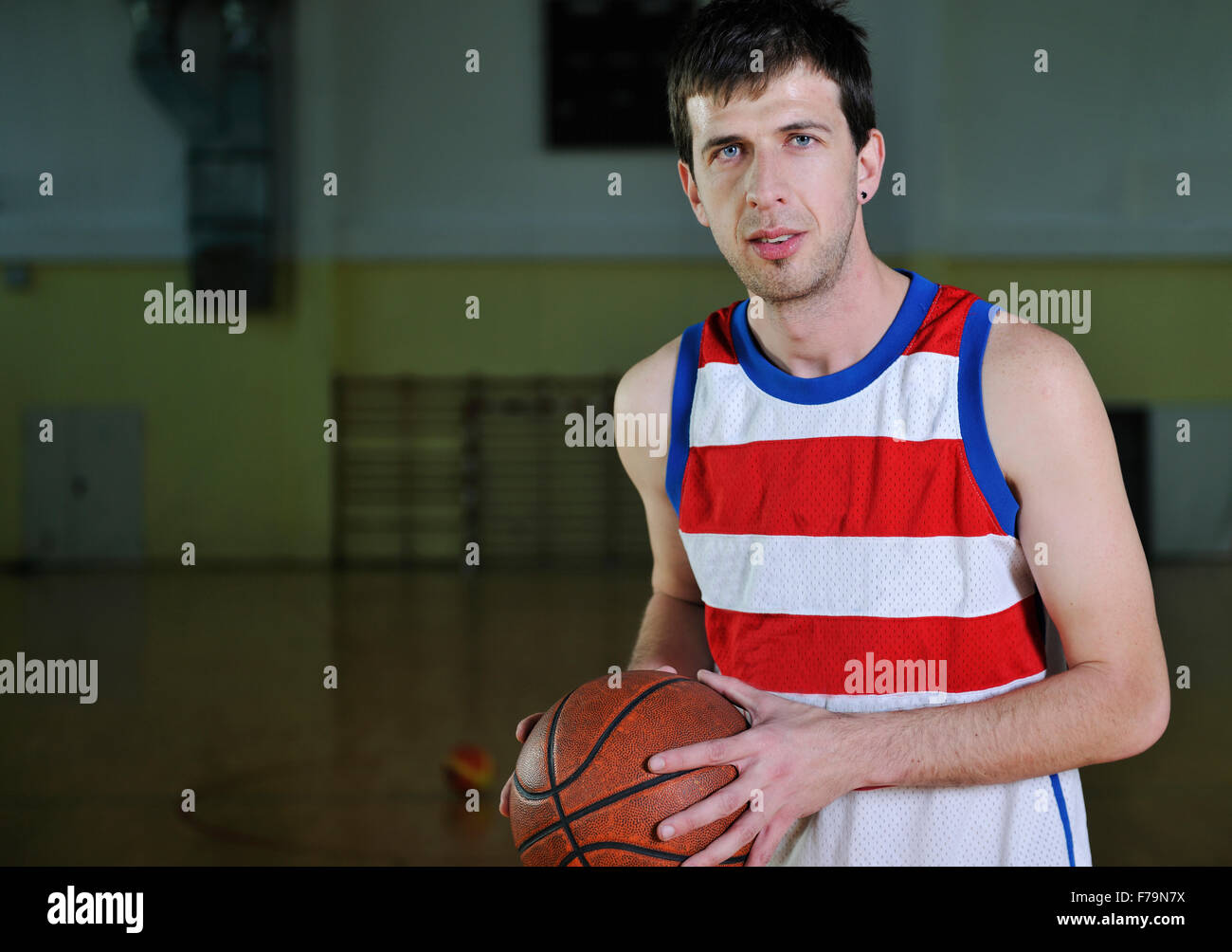 one healthy young man play basketball game in school gym indoor relax ...