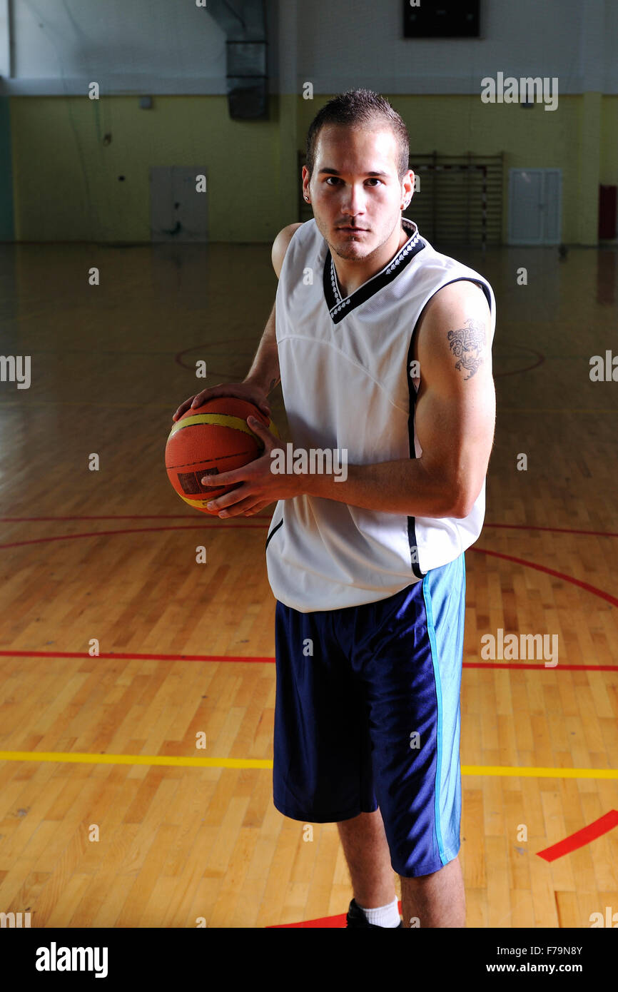 one healthy young man play basketball game in school gym indoor relax ...