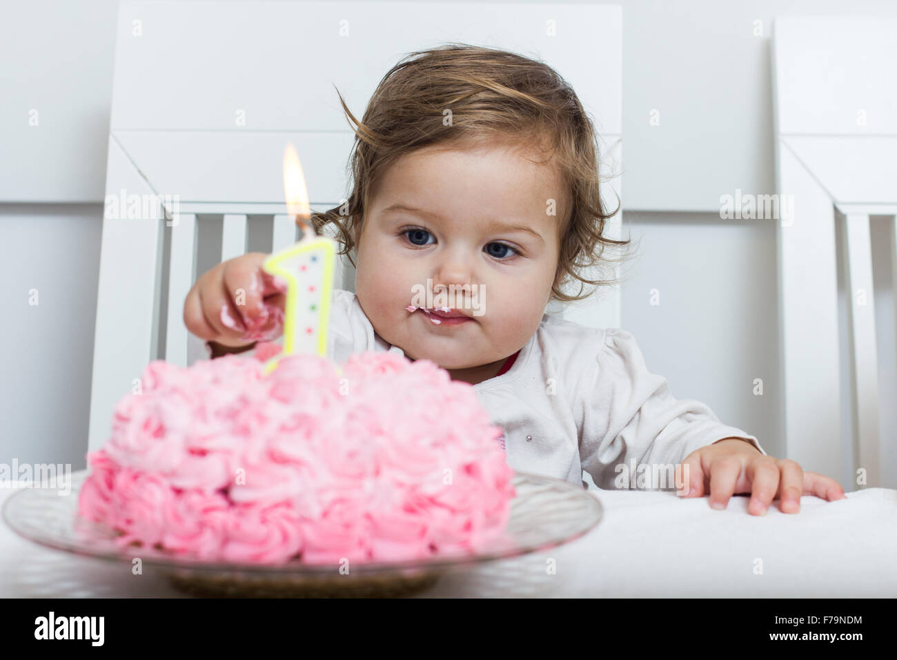 Celebrating First Birthday , portrait of cute little girl with cake ...