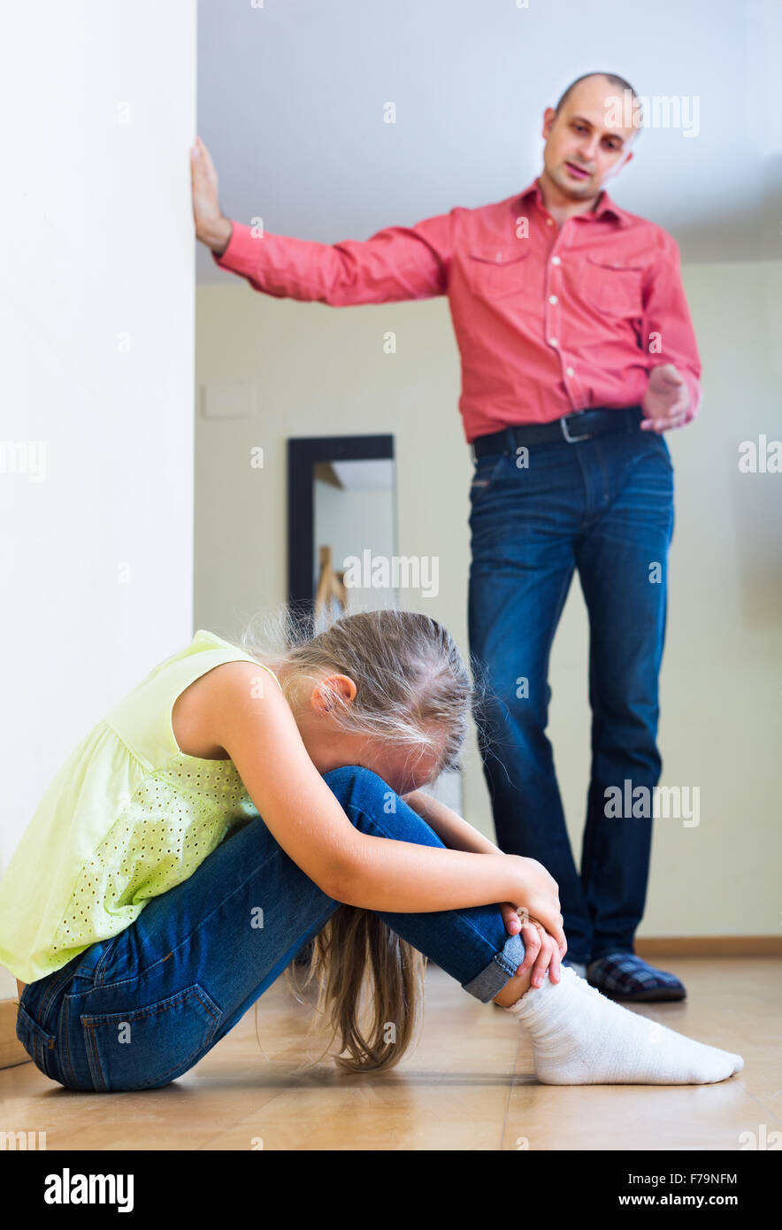 european father rebuking small daughter for offence at home Stock Photo ...