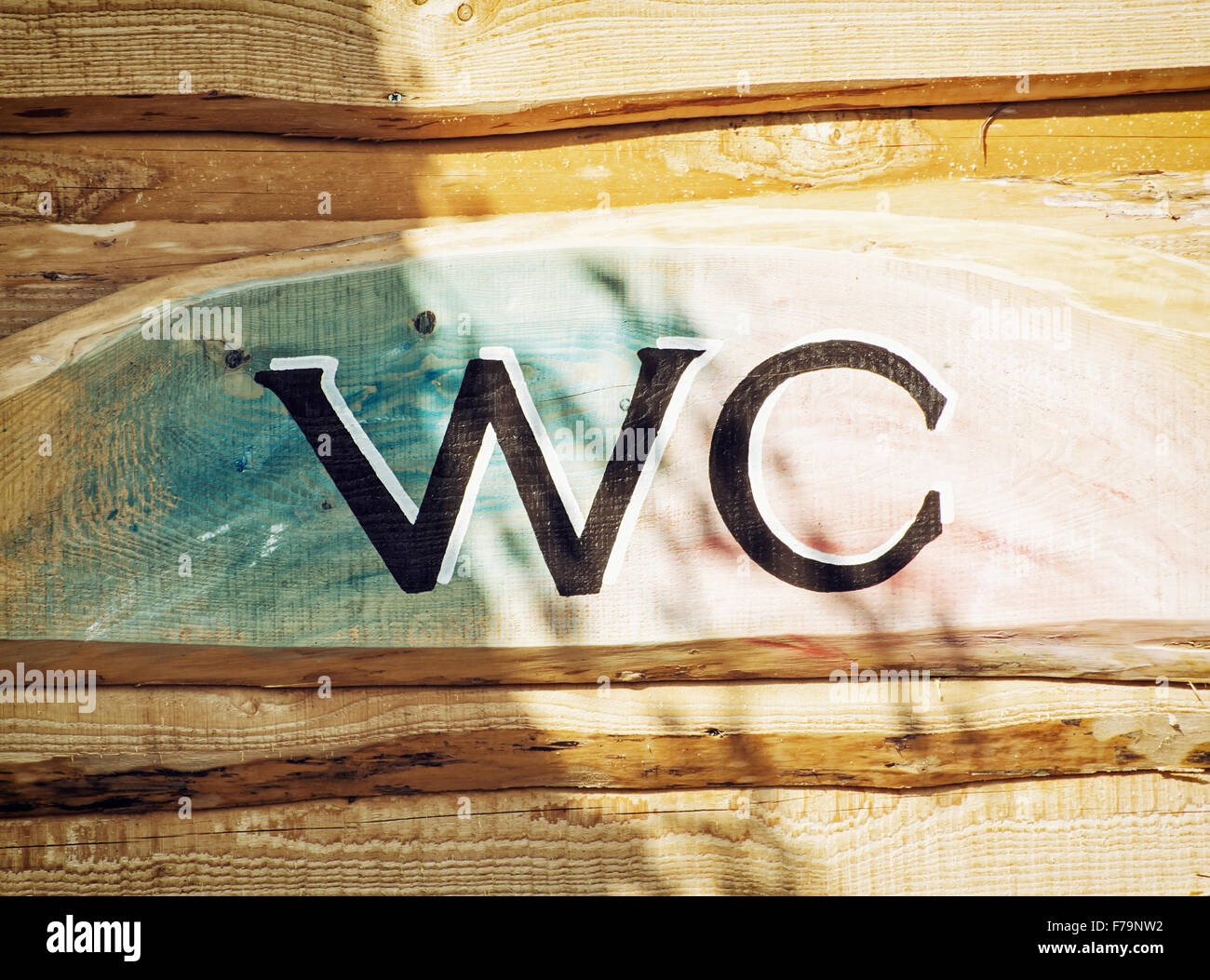 Sign WC on the wooden background. Symbol of toilet Stock Photo - Alamy