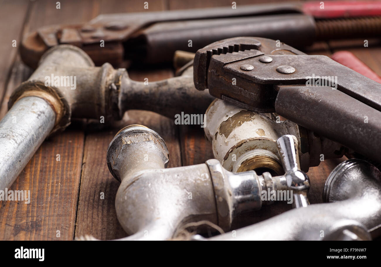 plumbing tools lying with old pipes and faucets Stock Photo - Alamy