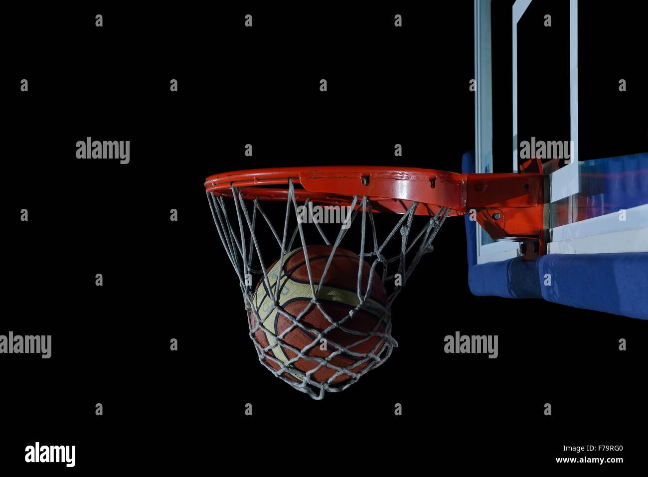 Basketball ball, board and net on black background in gym indoor Stock ...