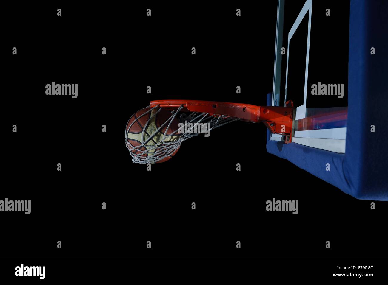 Basketball ball, board and net on black background in gym indoor Stock ...