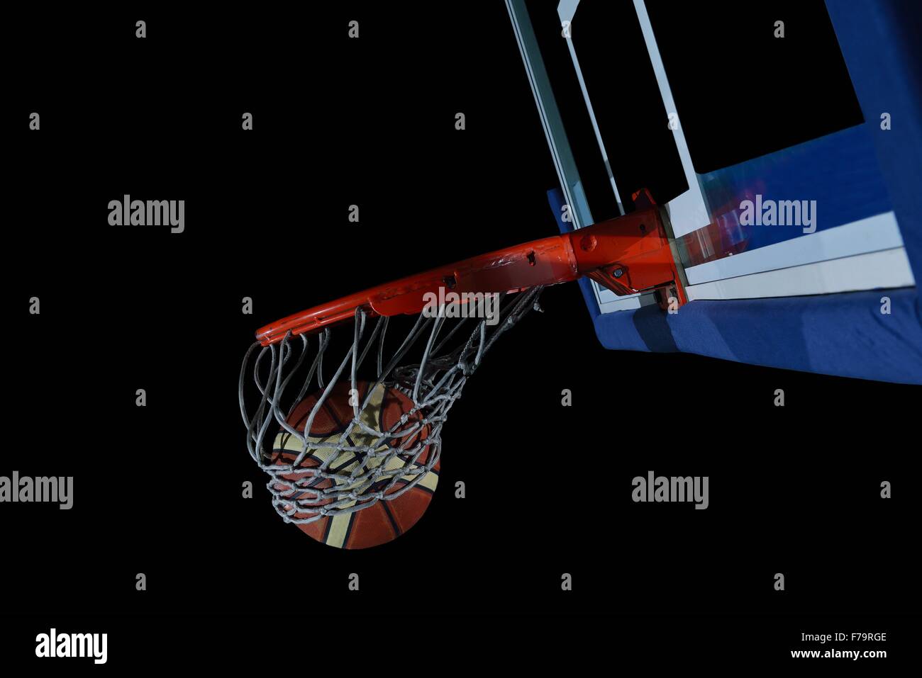 Basketball ball, board and net on black background in gym indoor Stock ...