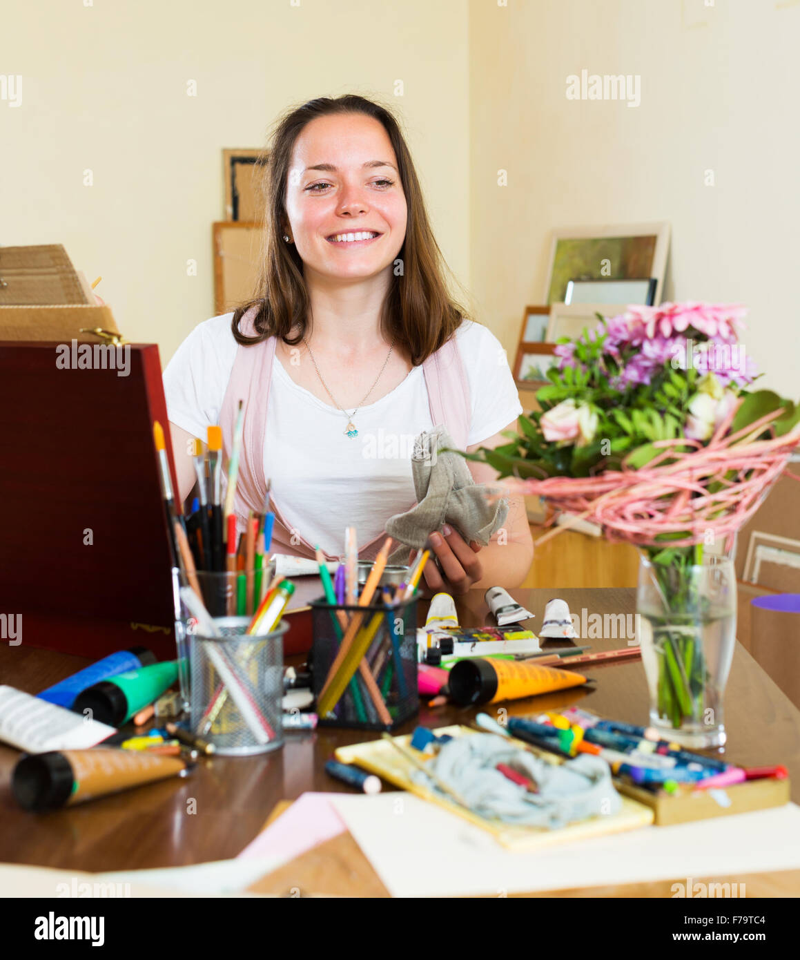 Smiling artist in the process of creating a new picture Stock Photo - Alamy