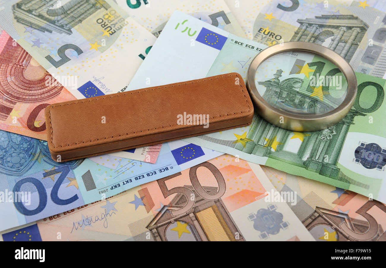 Magnifying glass lying on Euro banknotes, closeup, shallow DOF Stock ...