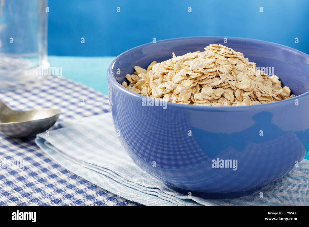 Oats in blue bowl on breakfast table Stock Photo - Alamy