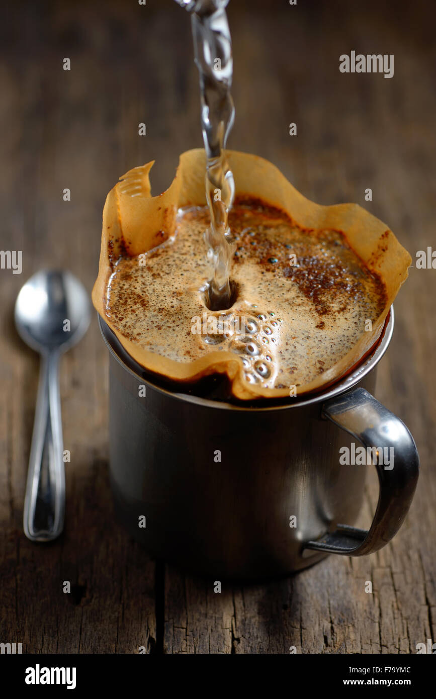 Ground coffee in cup and filter holder Stock Photo - Alamy