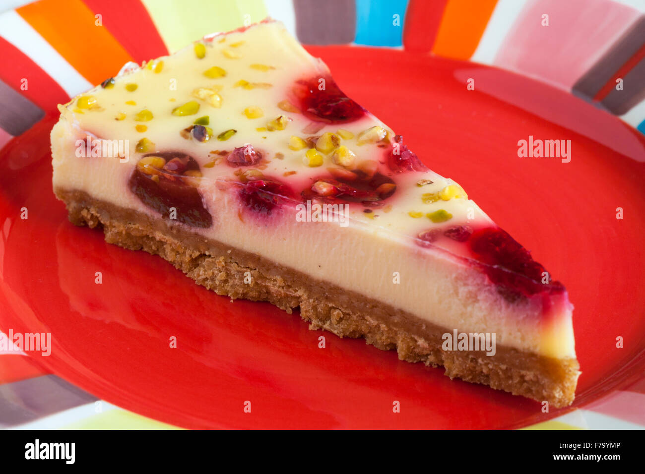 Tesco finest Raspberry & Pistachio cheesecake slice on red colourful ...