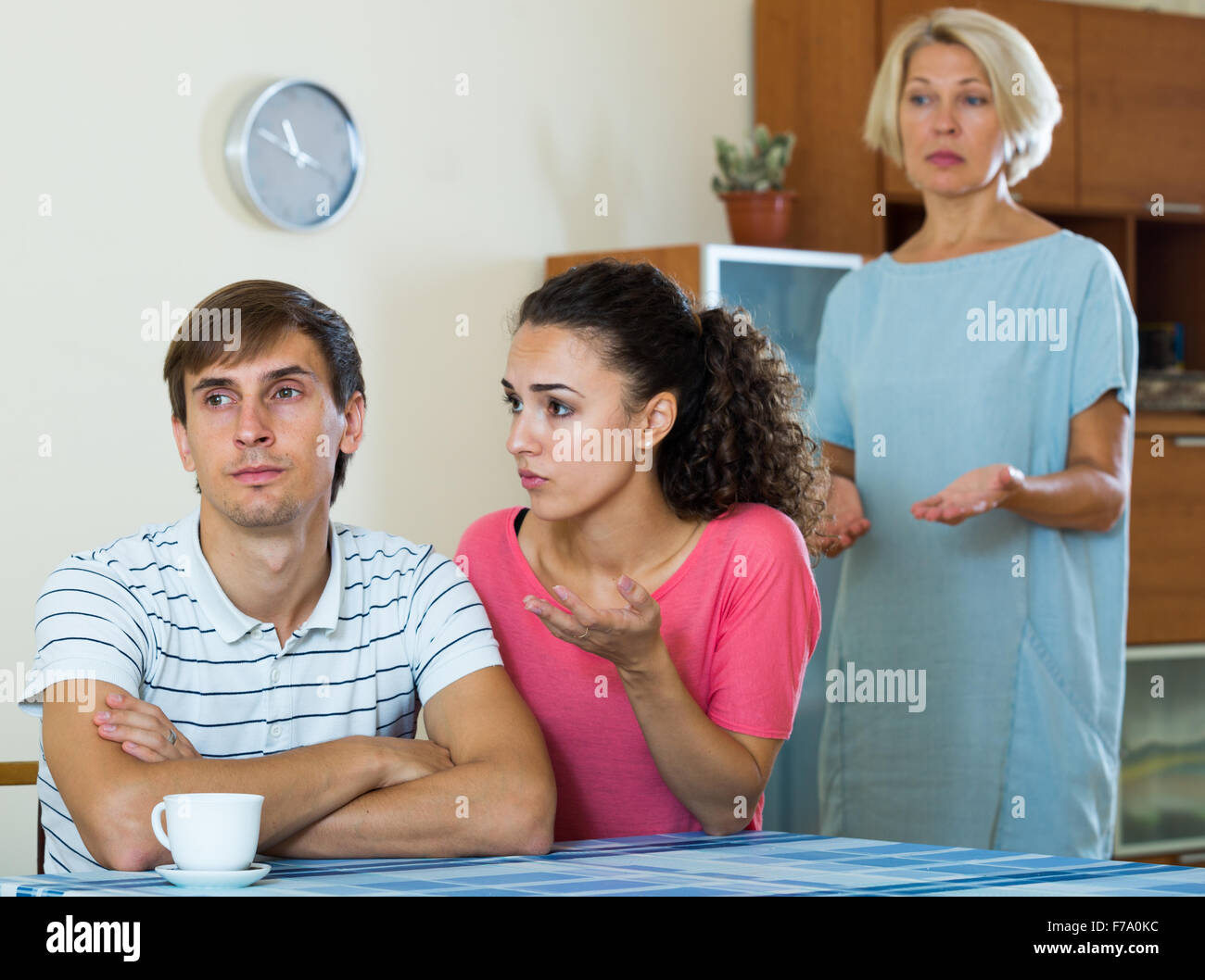 Adult guy having argue with wife and mother-in-law Stock Photo - Alamy