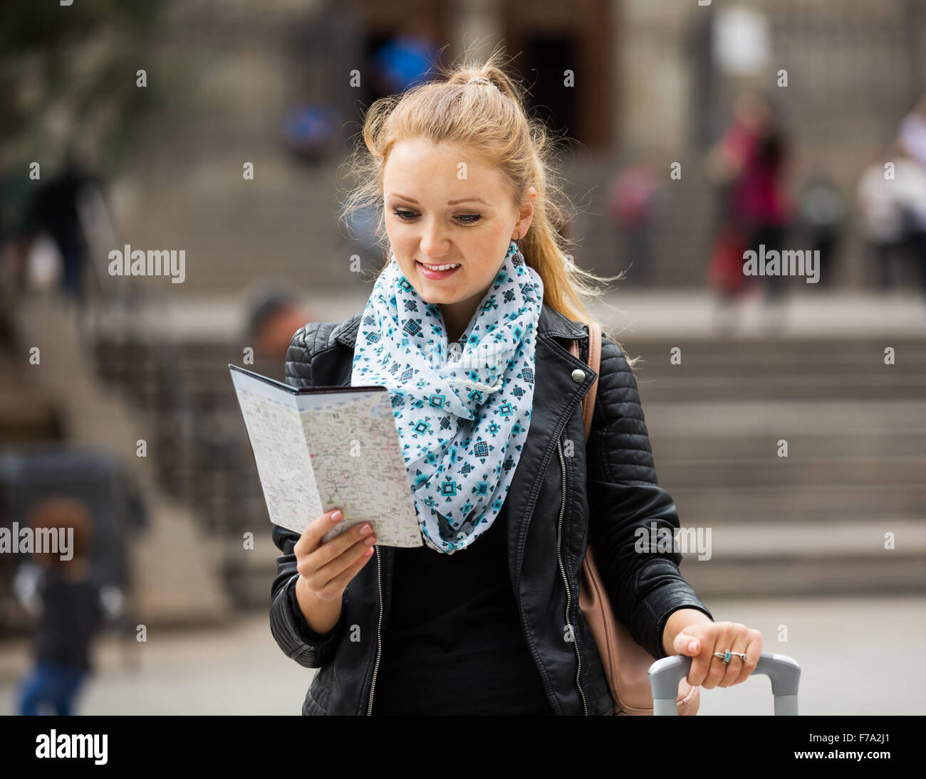 Female traveller checking route on city map outdoors Stock Photo - Alamy