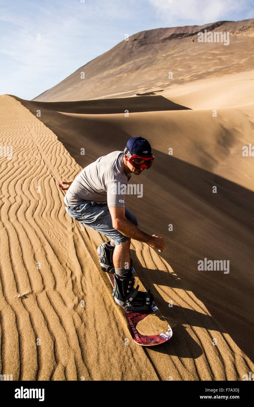Sandboarding on Caramucho dunes, in Atacama Desert. Iquique, Tarapaca ...