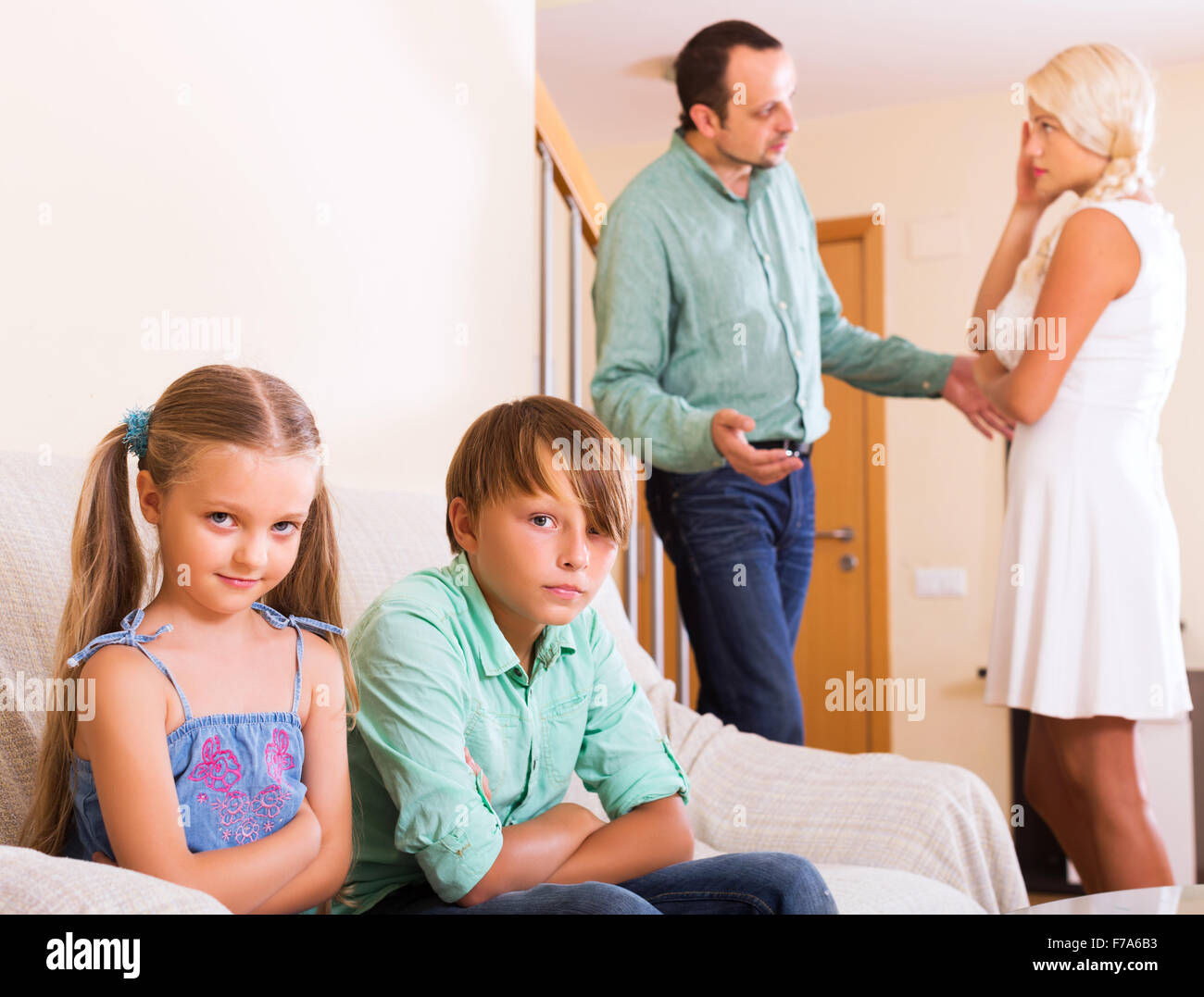 Sad siblings waiting when parents stop screaming indoors Stock Photo ...