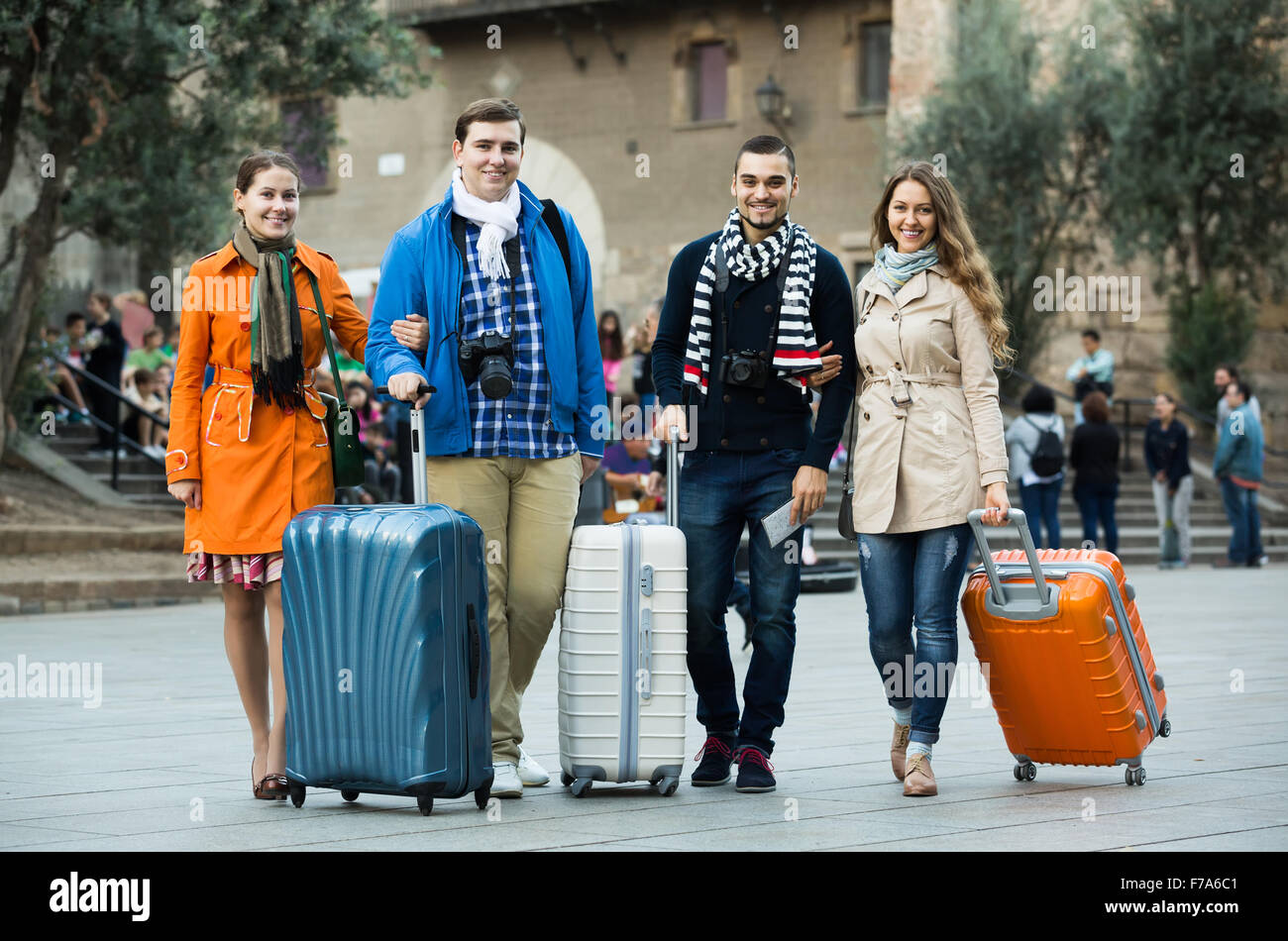 smiling russian travelers with baggage sightseeing and smiling in ...