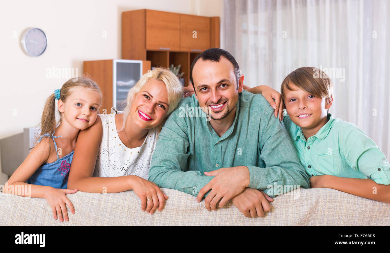 young european parents with two children posing in home interior Stock ...