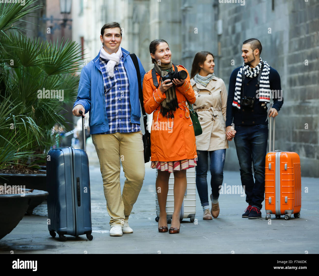 young russian travelers with baggage sightseeing and smiling in autumn ...