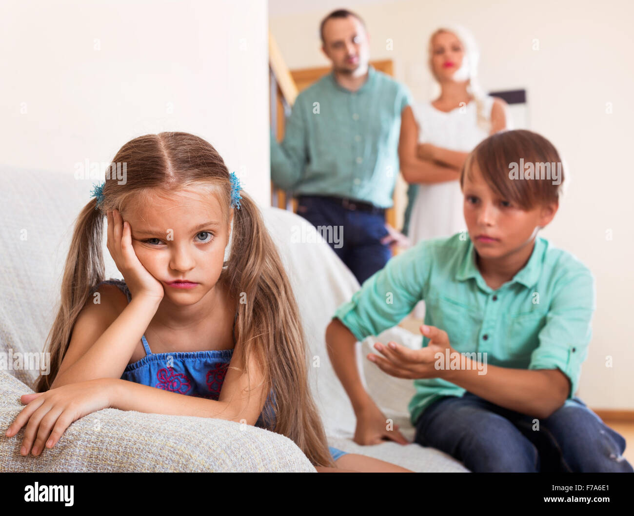 Brother calms angry sister in presence of parents Stock Photo - Alamy