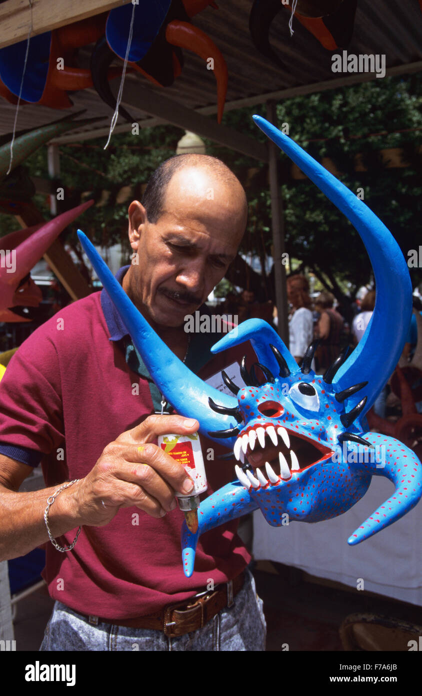 A carnival mask maker at work during a handicrafts fair, Plaza Las ...