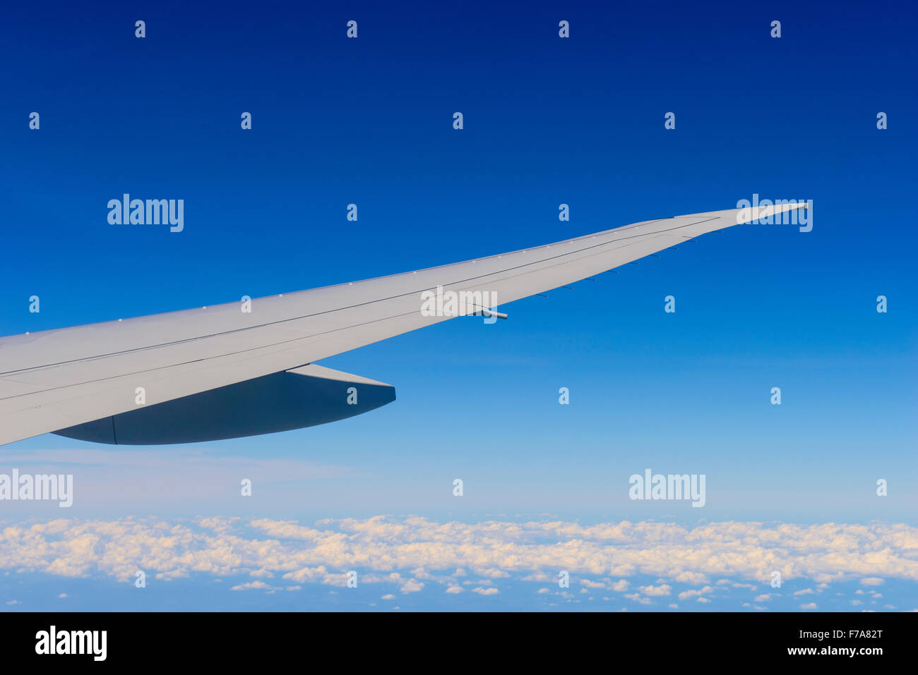 Airplane flying over clouds Stock Photo - Alamy