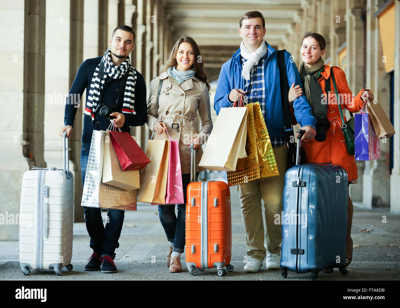 Smiling young adults chasing streets in shopping tour Stock Photo - Alamy
