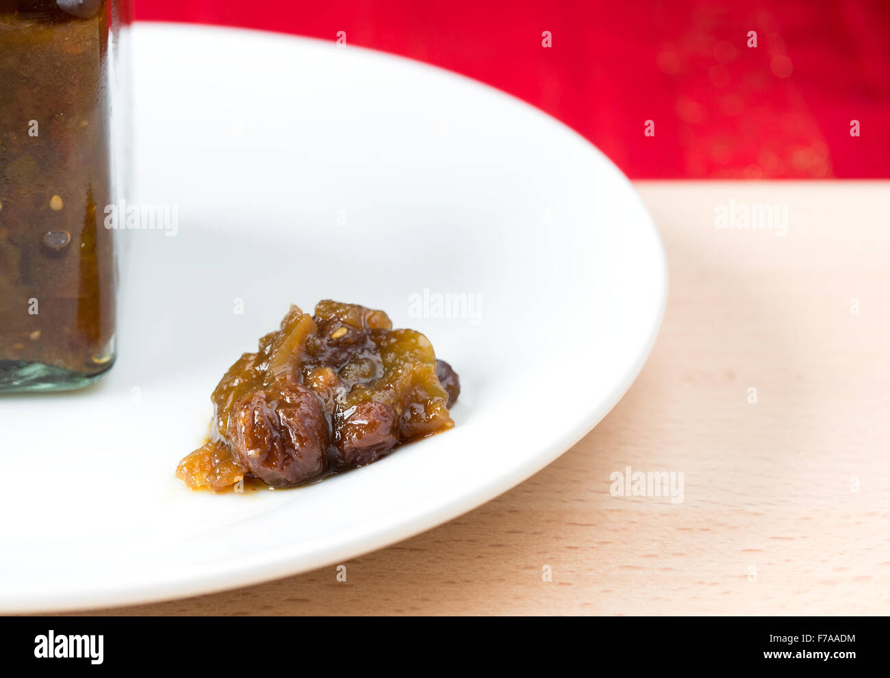 Homemade tomato chutney on a plate with jar Stock Photo - Alamy