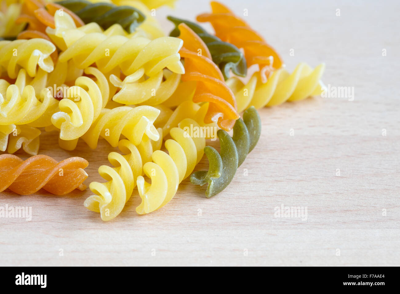 Multicolor fusilli pasta on a wooden board Stock Photo - Alamy