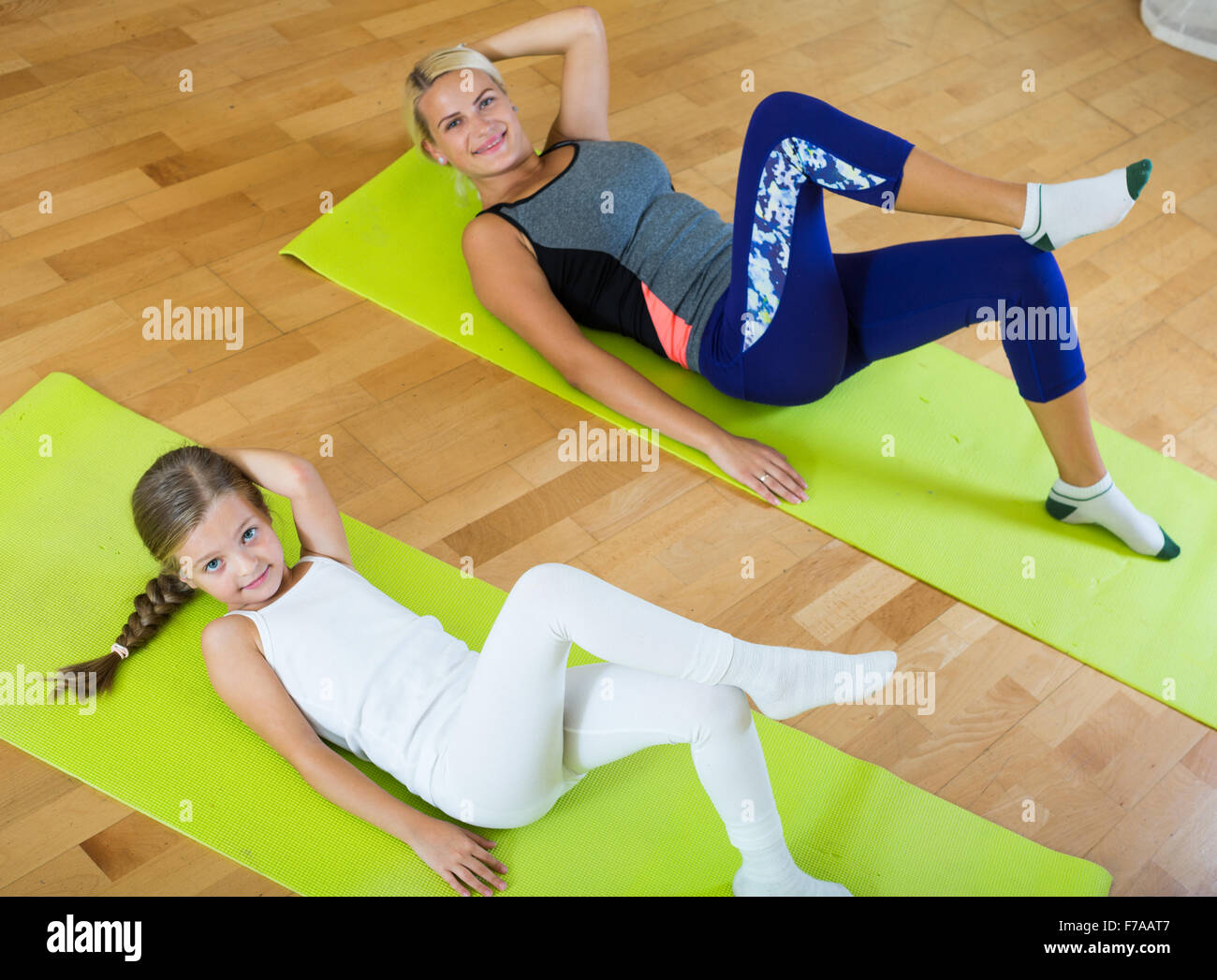 Young mother with small daughter working out and smiling Stock Photo ...