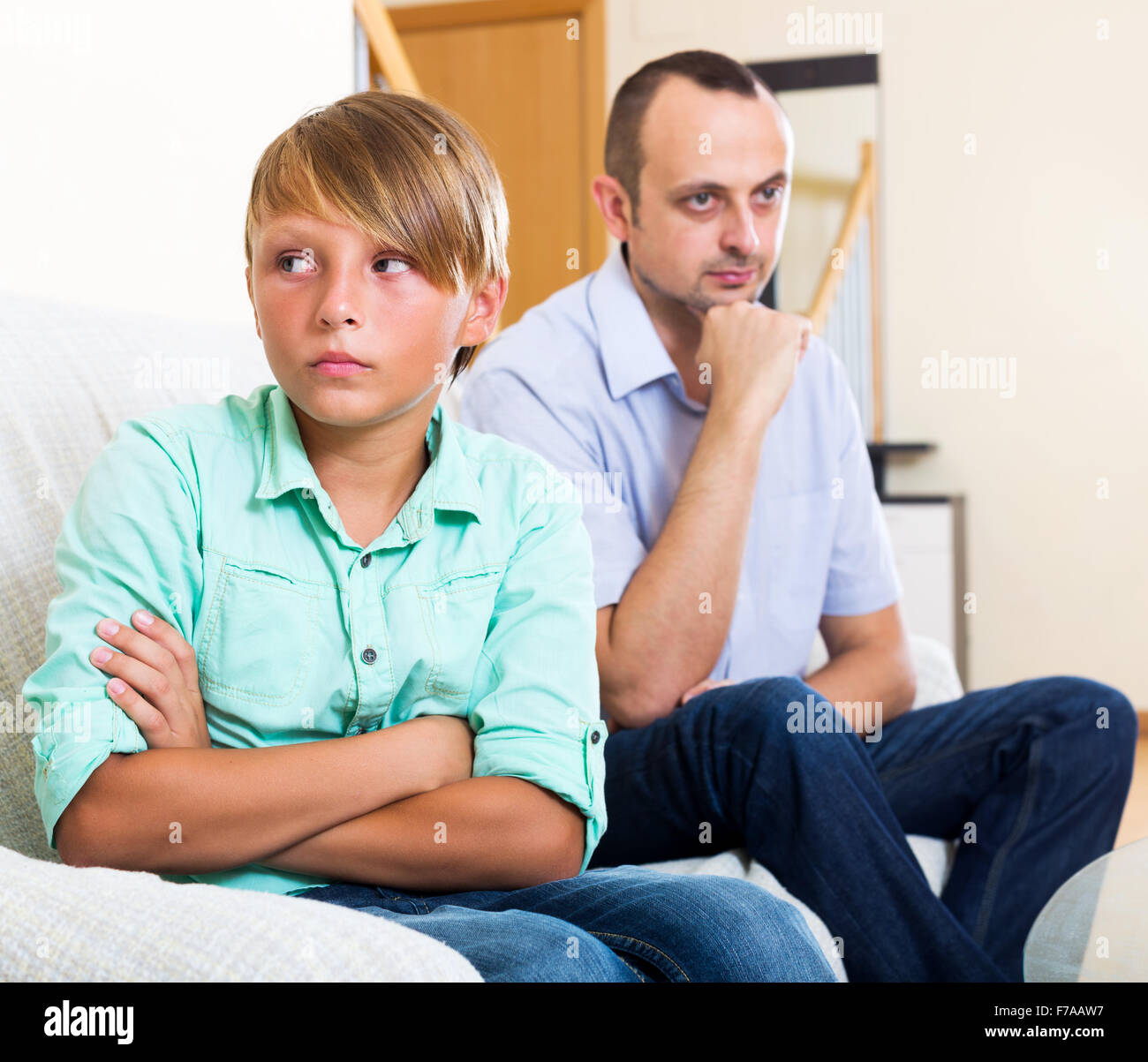 Tired father and sad son having quarrel Stock Photo - Alamy
