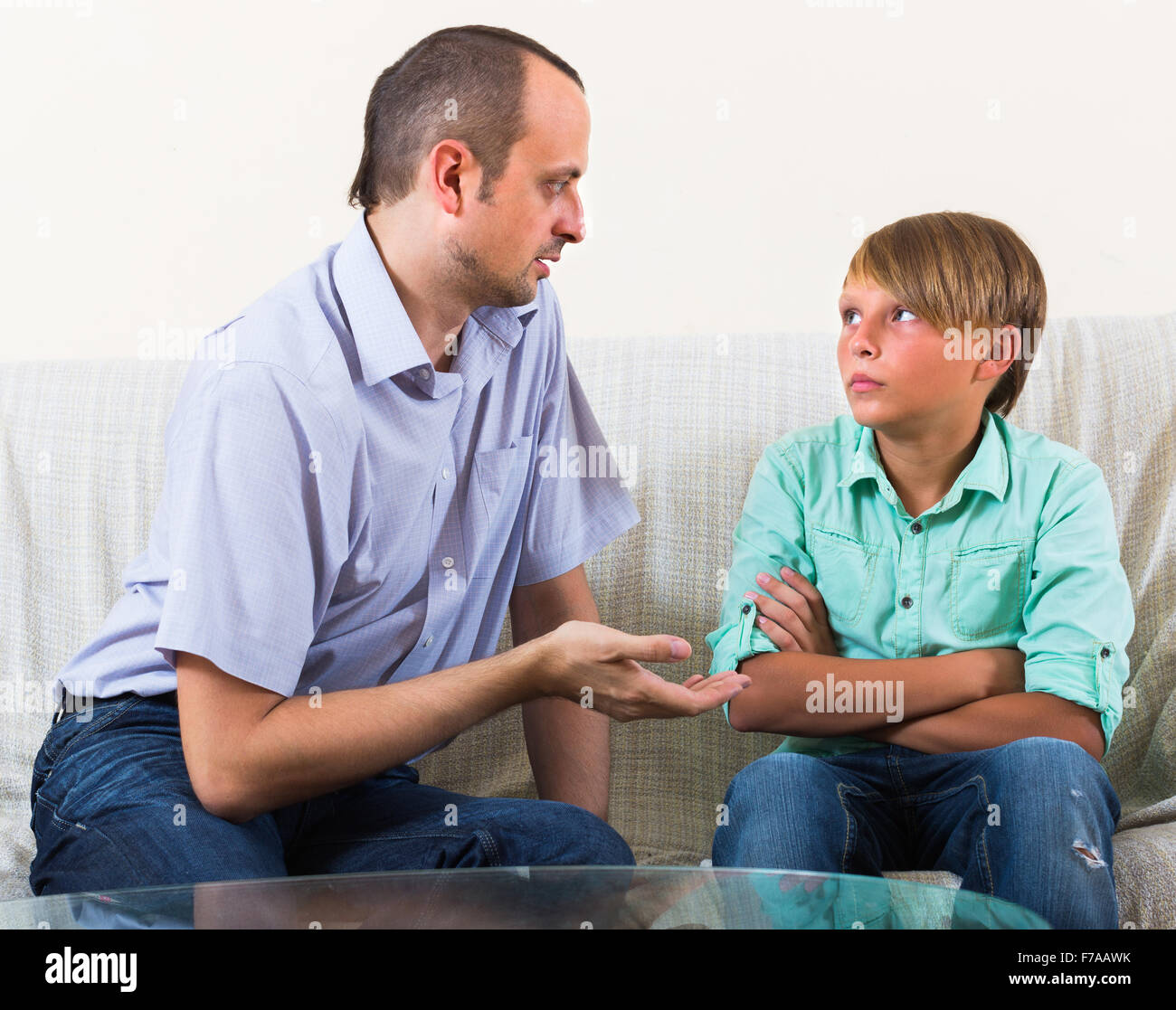 Portrait of father and boy having important conversation Stock Photo ...