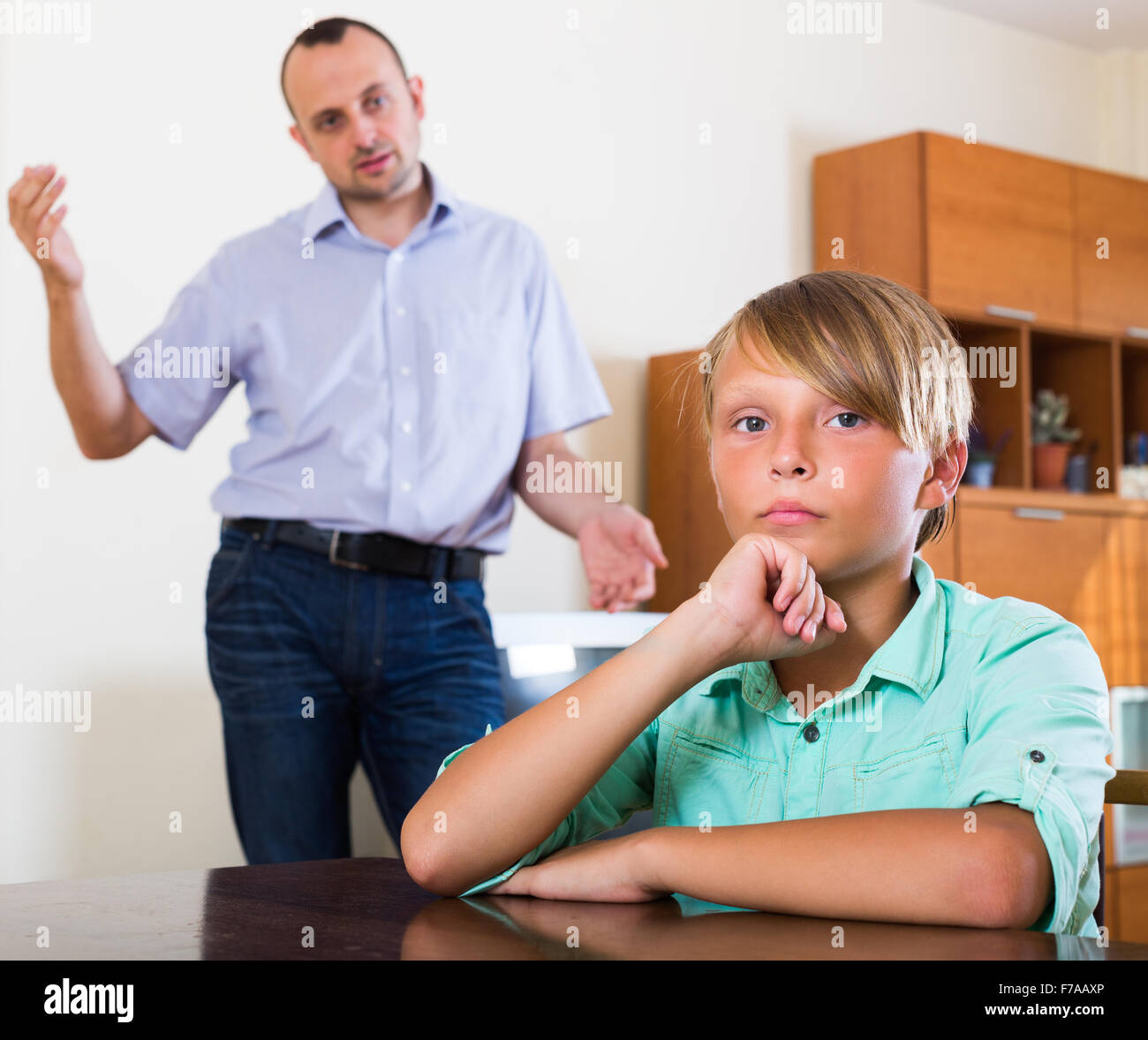 Offended teenager having conflict of arguing with father at home Stock ...