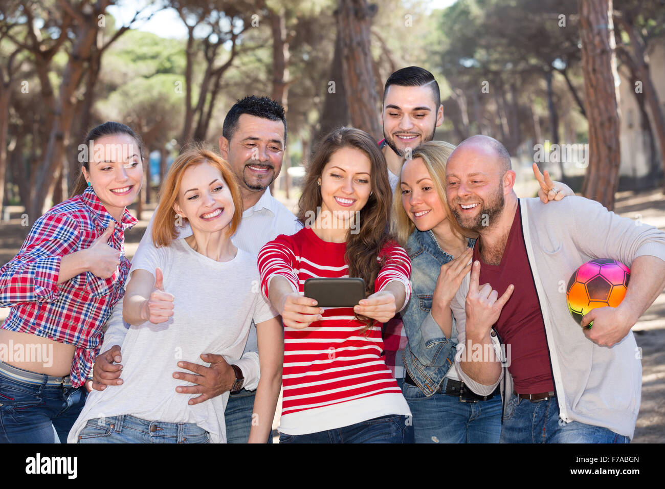 Positive colleagues taking mutual photo at summer corporate party Stock ...