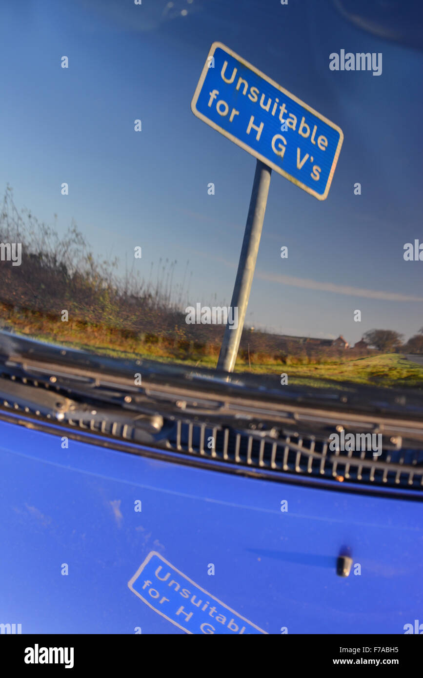 unsuitable for hgv's warning sign on country road reflected in vehicle ...