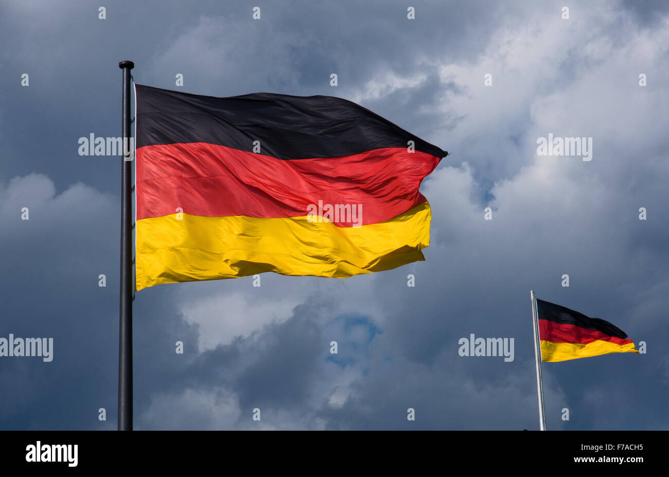 Two German flags in front of dark clouds Stock Photo - Alamy