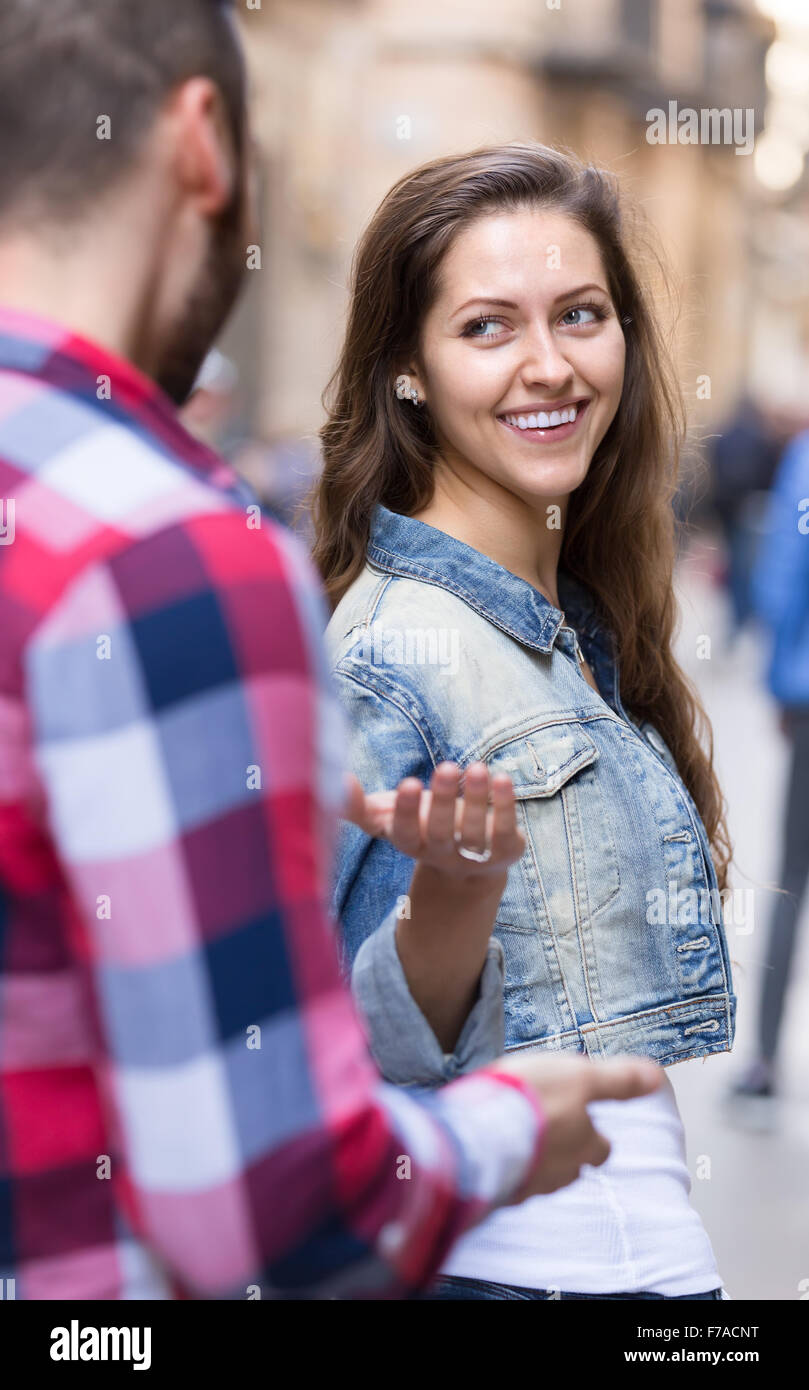 happy guy trying to get acquainted with pretty girl outdoors Stock ...