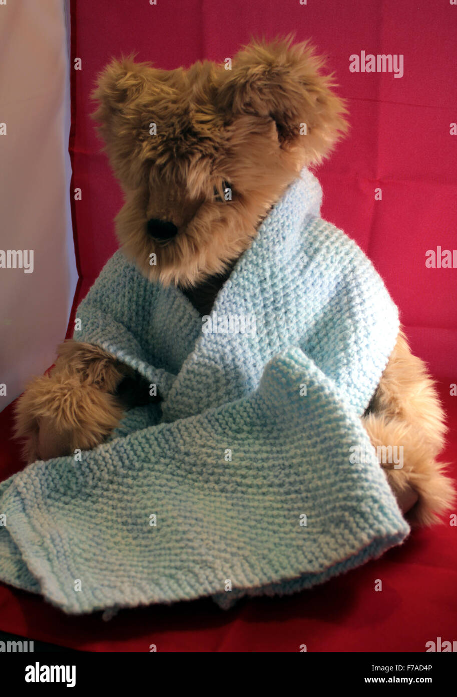 Hand knitted blue scarf being worn by a teddy bear Stock Photo - Alamy