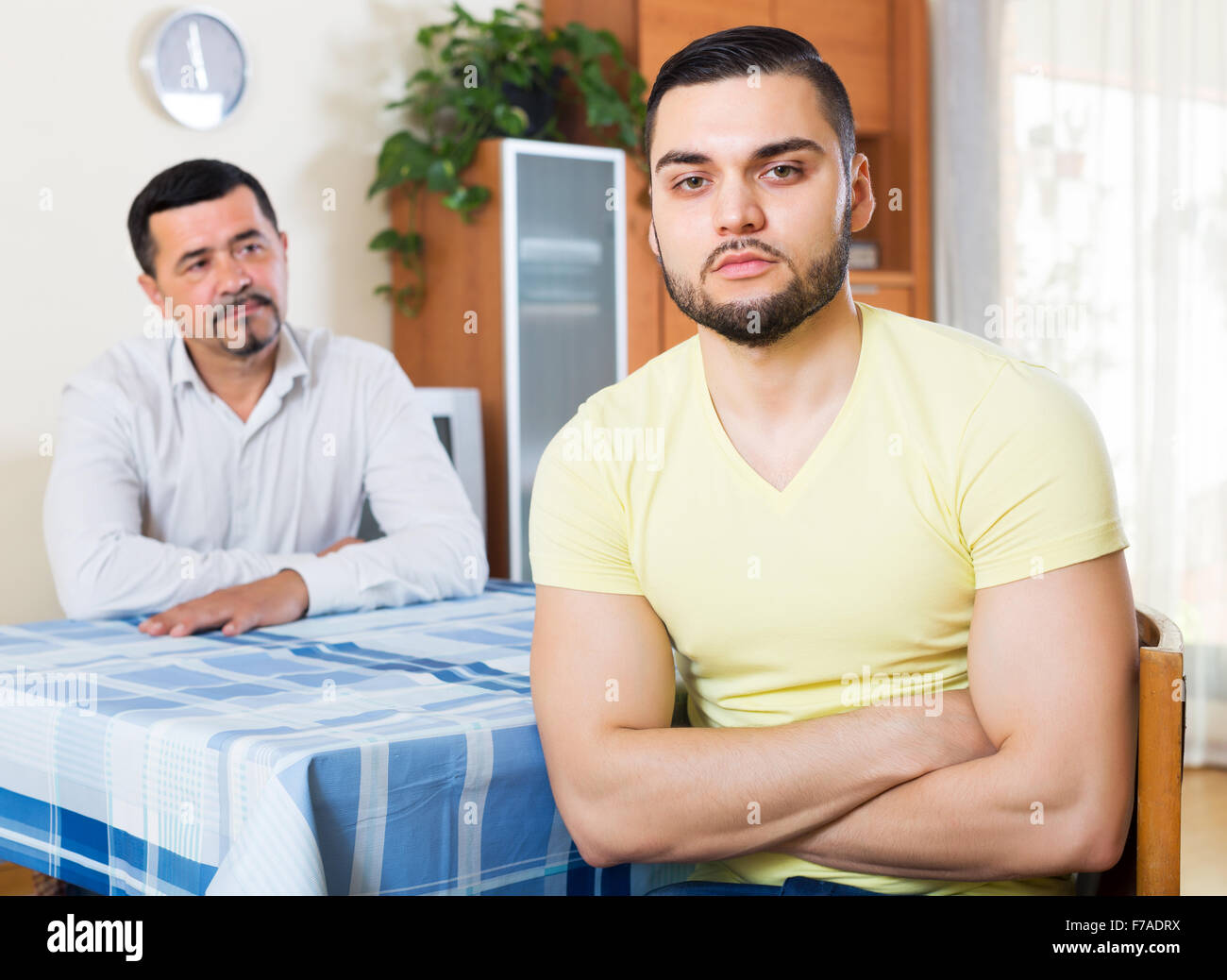 Portrait of two upset despair male adults arguing about something in ...