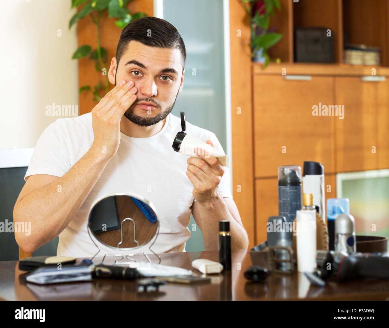 portrait man applying cream from the tube Stock Photo - Alamy